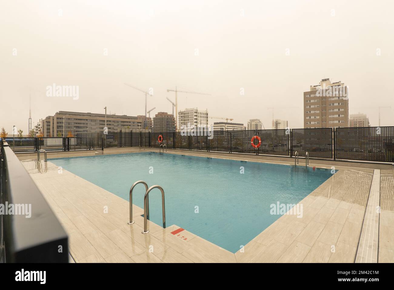 A newly built rectangular community pool in a new area of the city on a ...