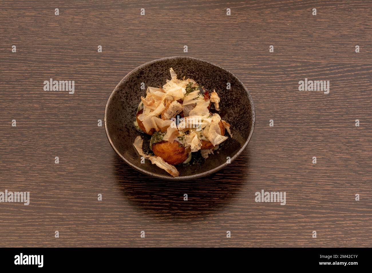 A nice bowl full of Takoyaki, which are delicious flour spheres that ...