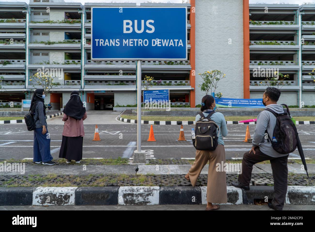 Several people were waiting for the Trans Metro Dewata Bus to arrive at ...