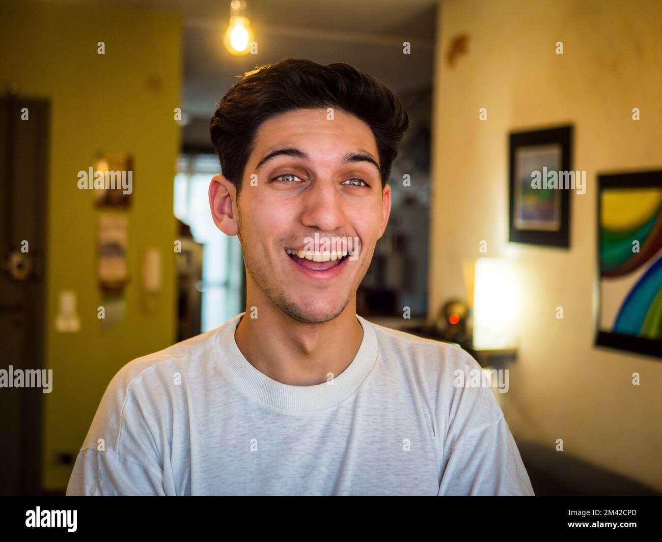 Attractive green eyed young man smiling very happy Stock Photo - Alamy
