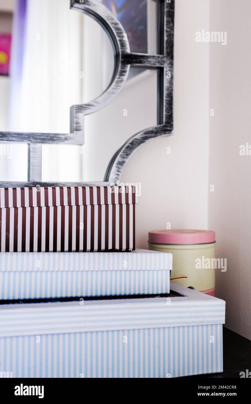 Corner of a room with a mirror with a scratched black frame and ...