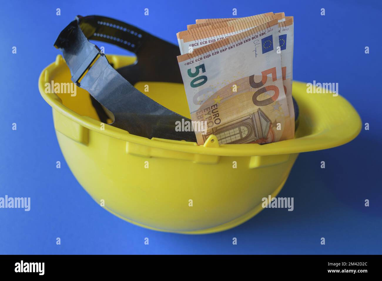 Budget investment in construction. Euro money banknotes and yellow ...