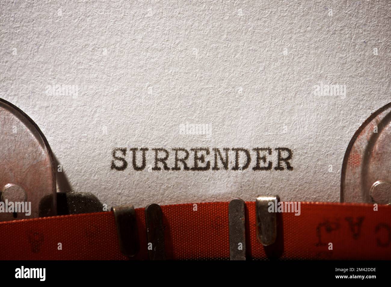 Surrender word written with a typewriter Stock Photo - Alamy
