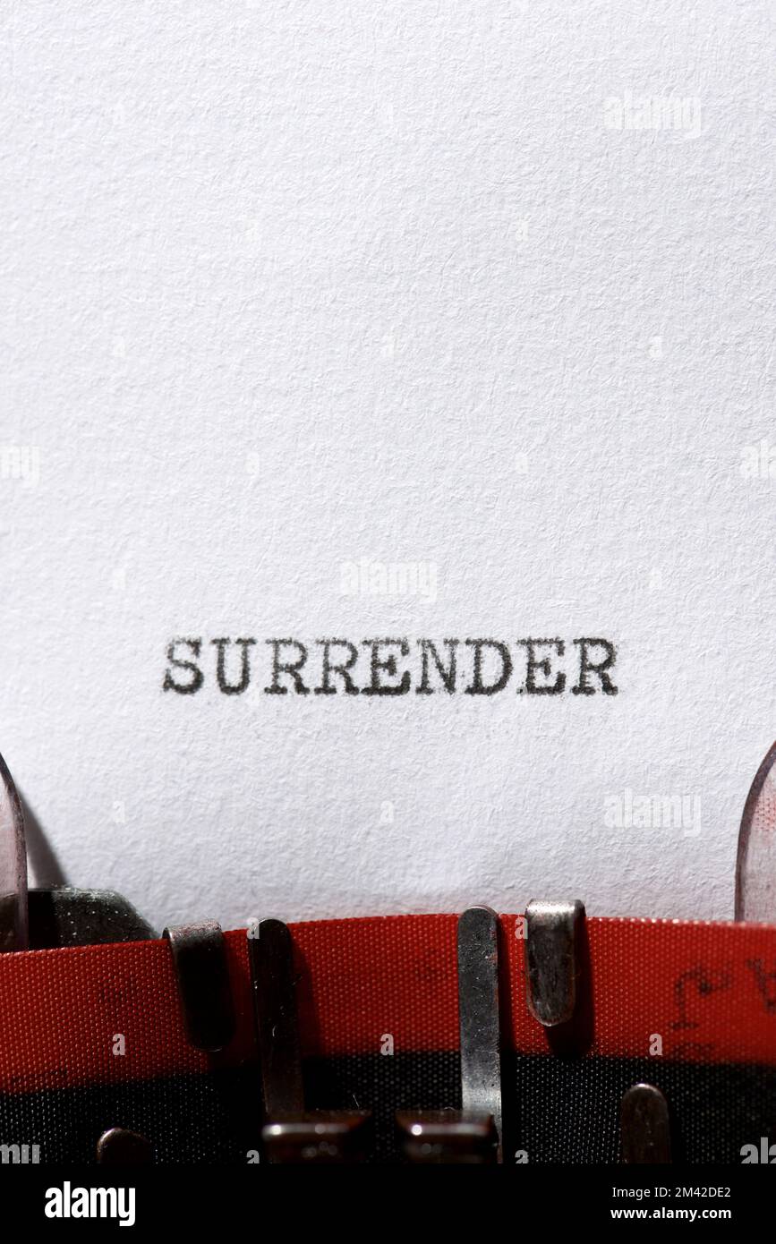 Surrender word written with a typewriter Stock Photo - Alamy