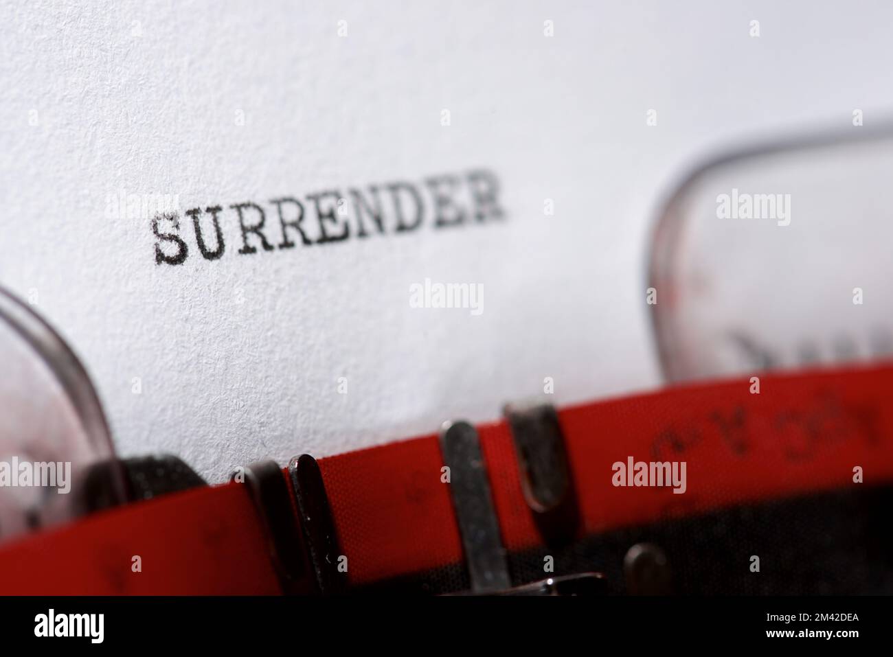 Surrender word written with a typewriter Stock Photo - Alamy