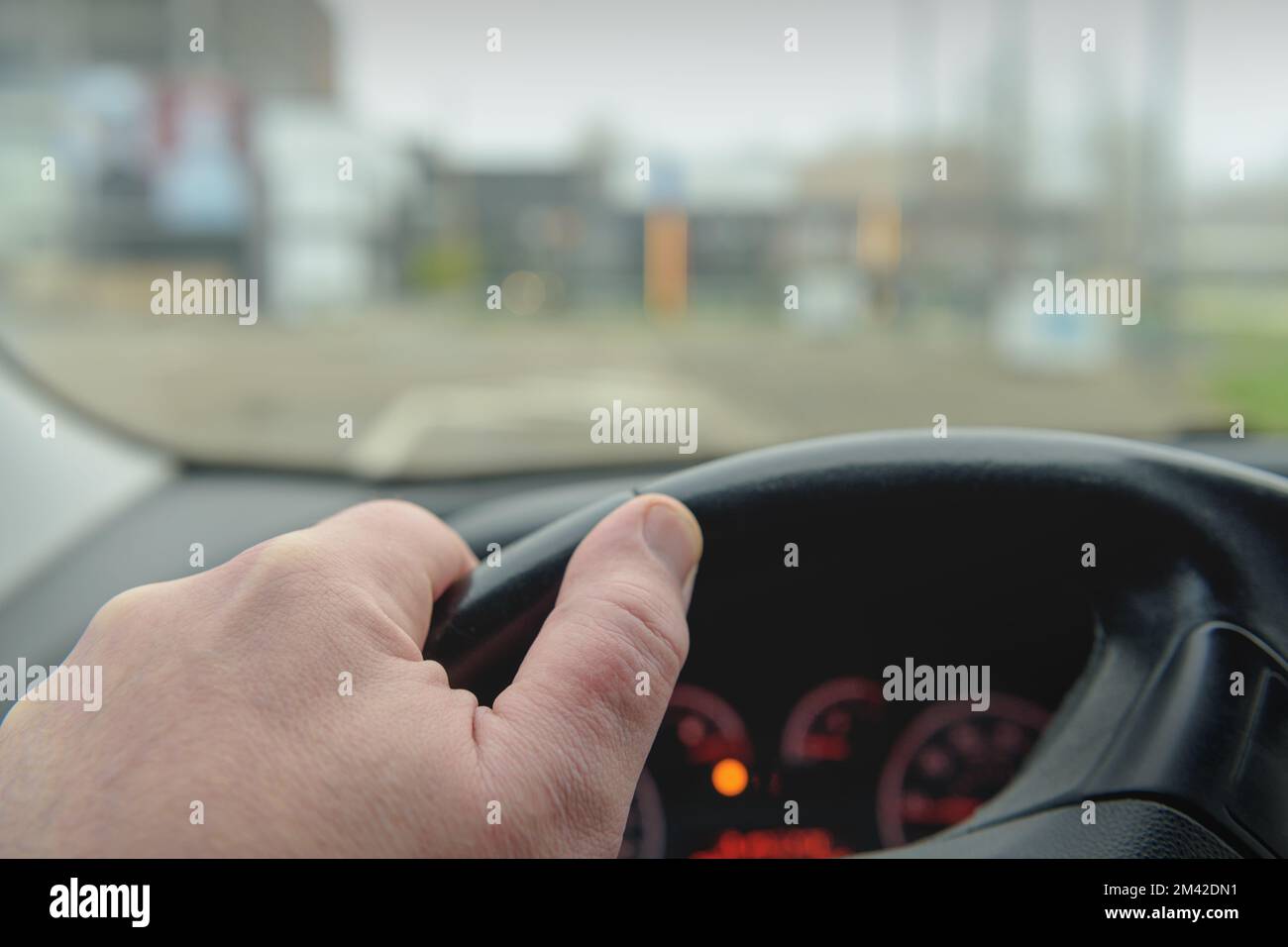Windshield and perspective of the road. Steering. Selected Focus. Hand ...