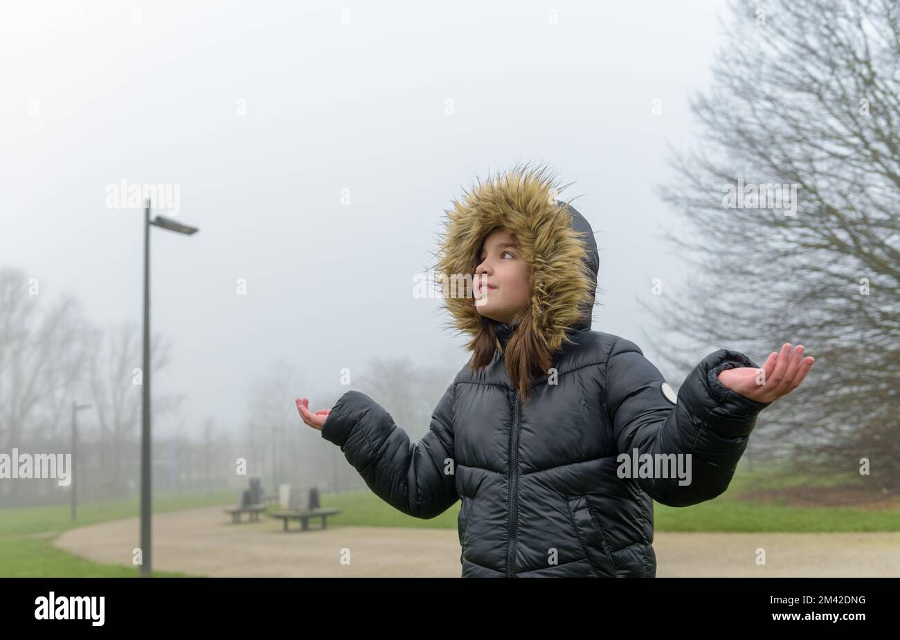 Winter without snow. Portrait of a teenager girl in the park in winter ...