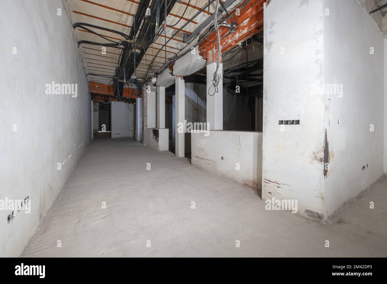 Raw room with interlocking metal beams in a renovated building and ...