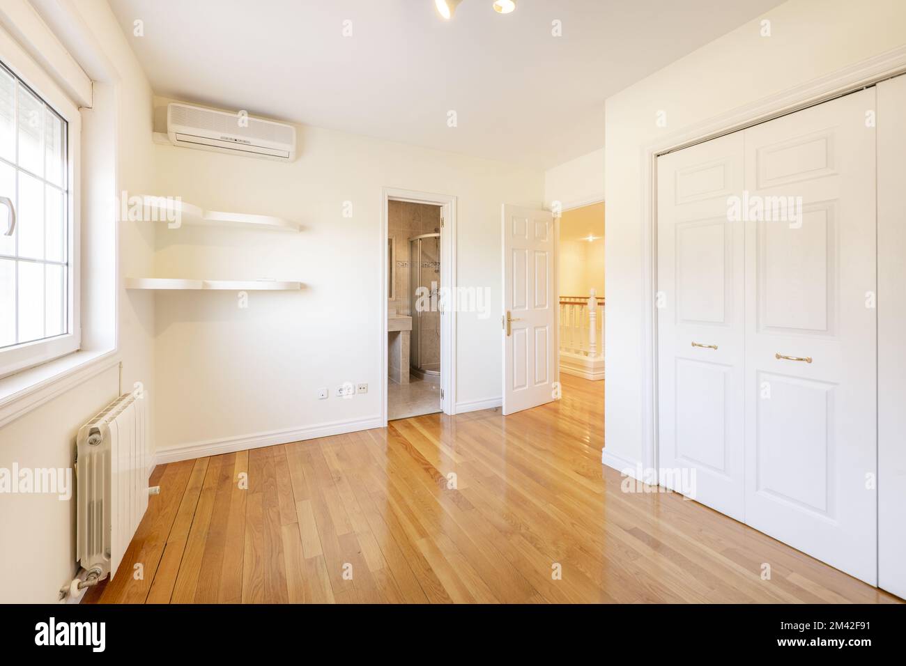 Empty room with fitted wardrobes with white lacquered doors, built-in ...