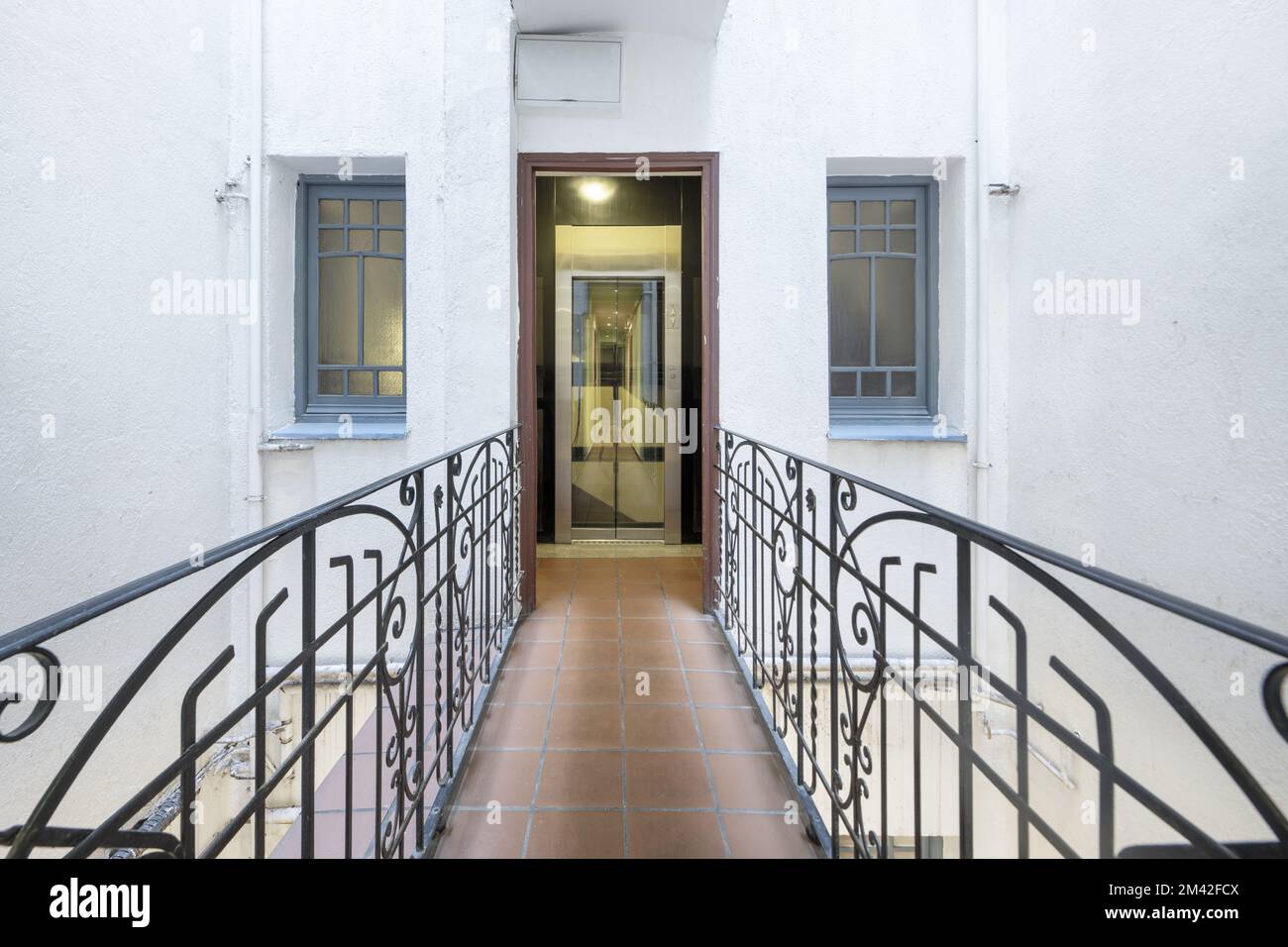 Bridge corridor of a house with wrought iron balustrades and access to ...