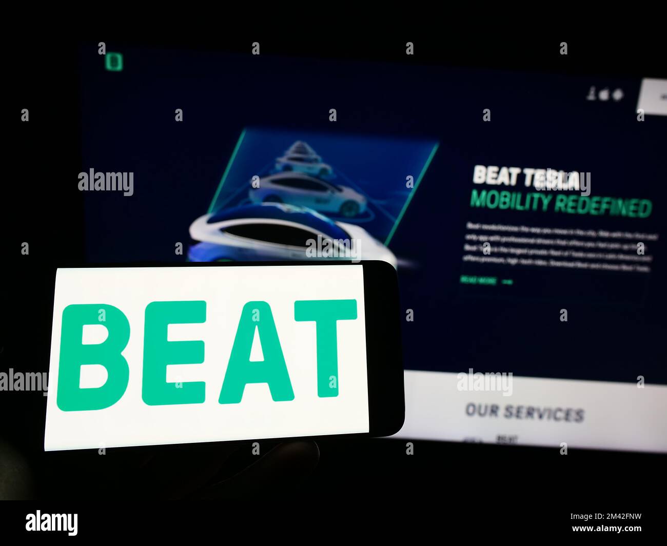 Person holding mobile phone with logo of taxi and ride-hailing app Beat ...