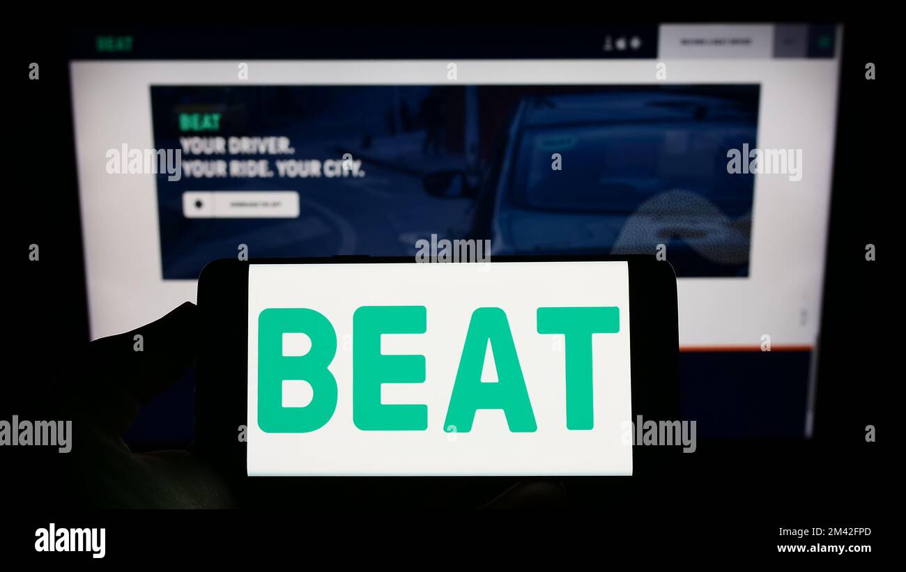 Person holding cellphone with logo of taxi and ride-hailing app Beat on ...