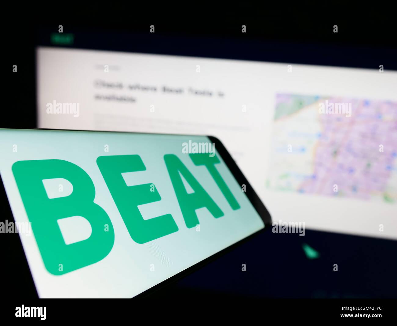 Cellphone with logo of taxi and ride-hailing app Beat on screen in ...