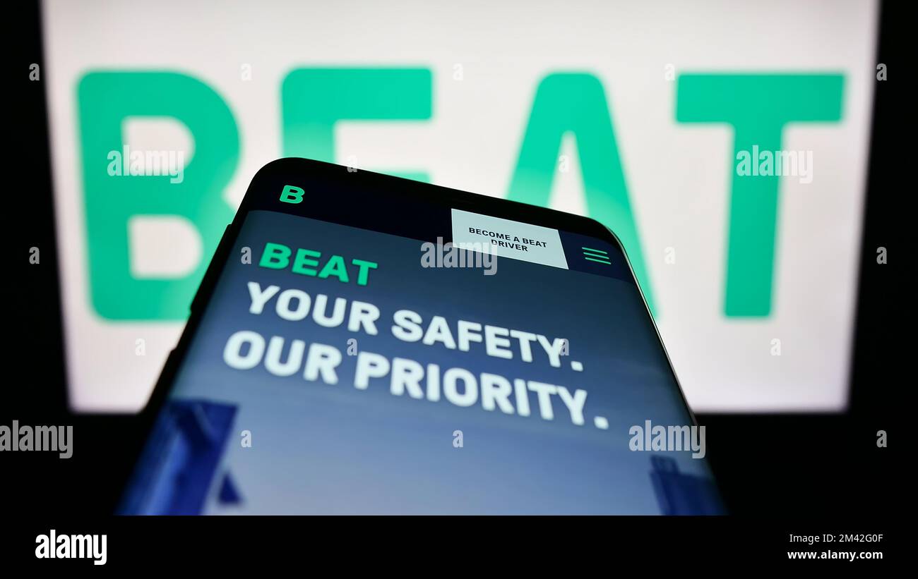 Mobile phone with website of taxi and ride-hailing app Beat on screen ...