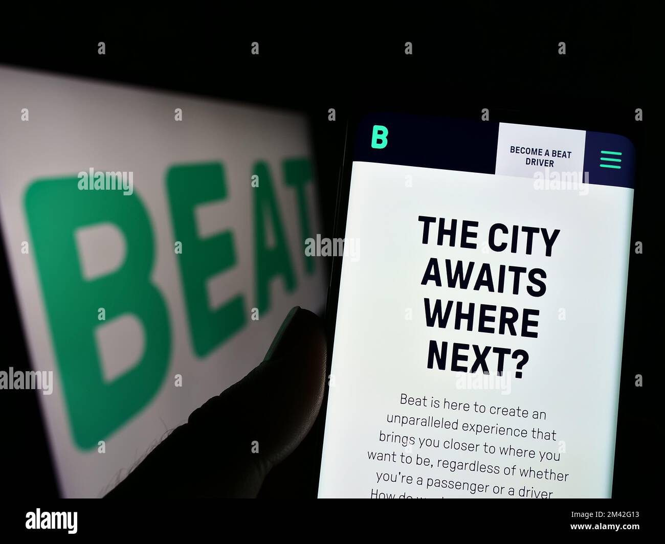 Person holding smartphone with webpage of taxi and ride-hailing app ...