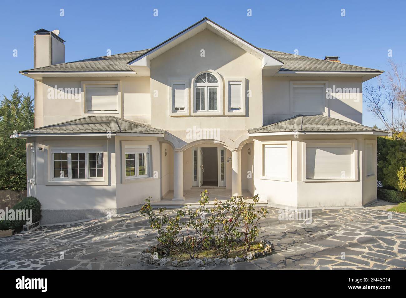 Facade of a two-story single-family residential house with slate roofs ...