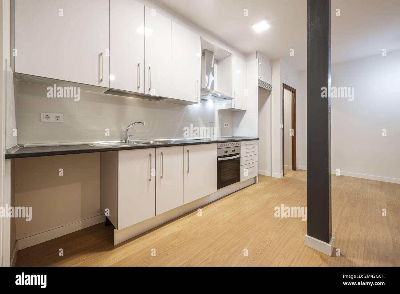 Conventional kitchen cabinets just installed in an open kitchen with a ...