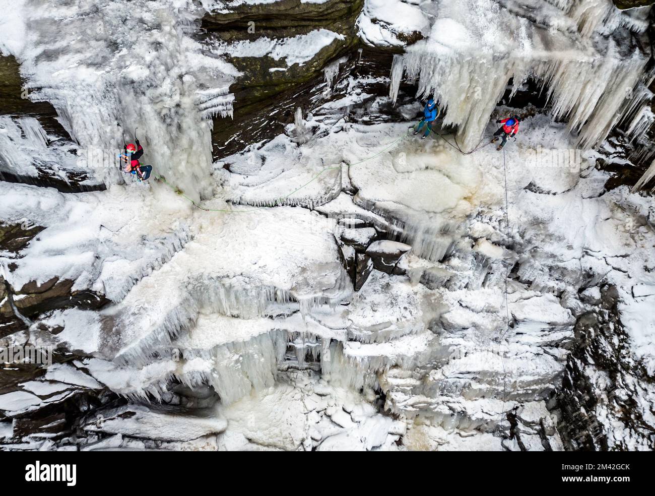 A man ice climbing on the frozen Kinder Downfall, High Peak in ...