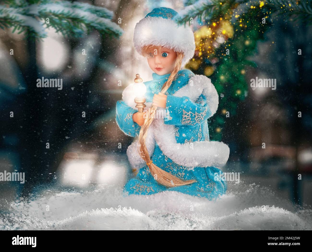 toy doll Snow Maiden in the snow with a flashlight in her hand Stock ...