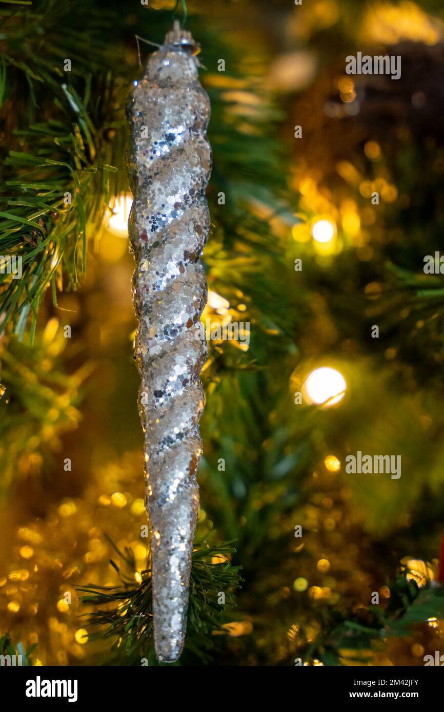 Icicle Christmas ornament in an artificial christmas tree with ...