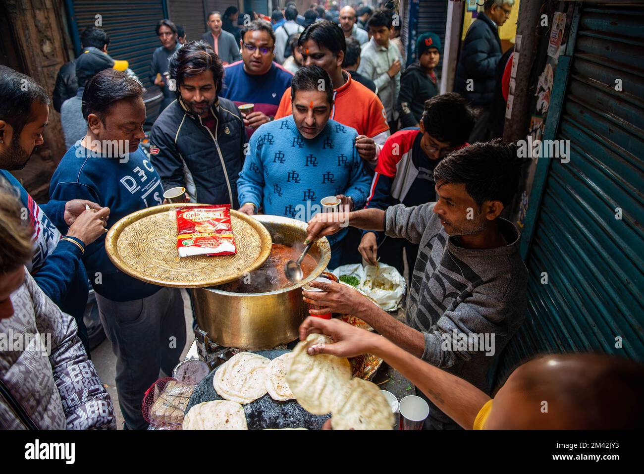 A man serving Lotan Chole Kulche at a famous street food shop in Old ... A man serving Lotan Chole Kulche at a famous street food shop in Old ...