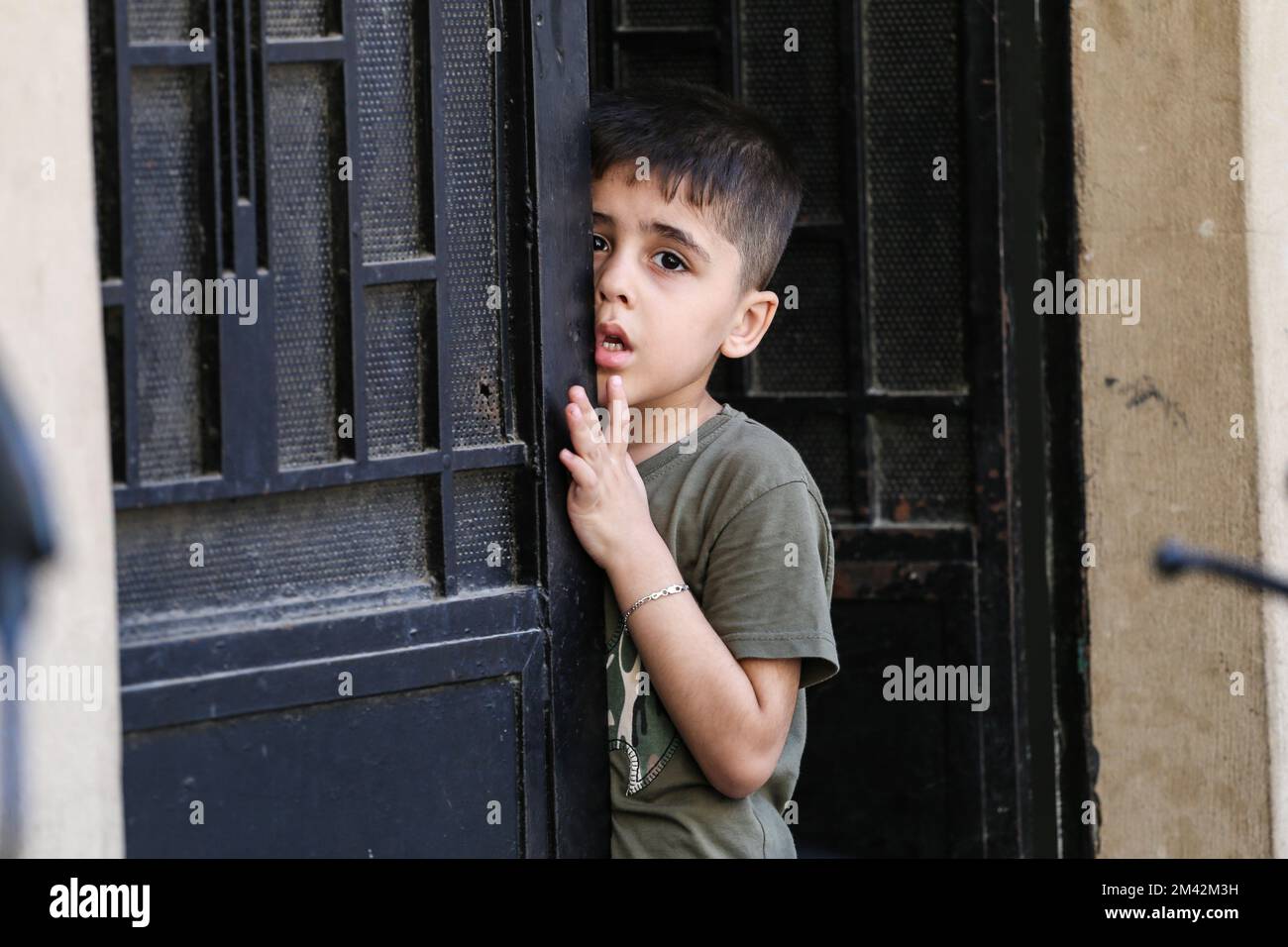 Boy standing behind door hi-res stock photography and images - Alamy