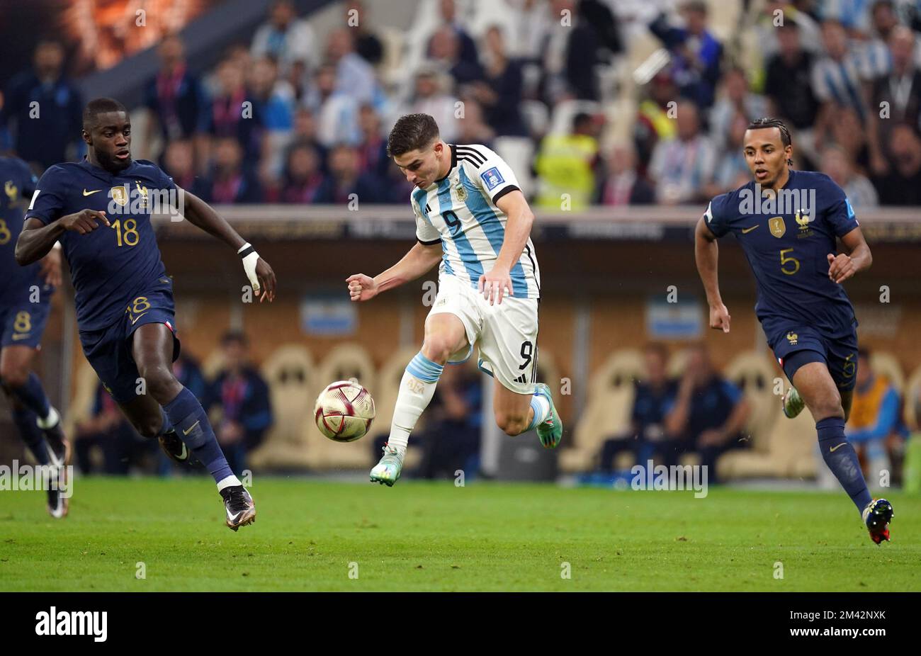 Argentina's Julian Alvarez (centre) gets between France's Dayot ...