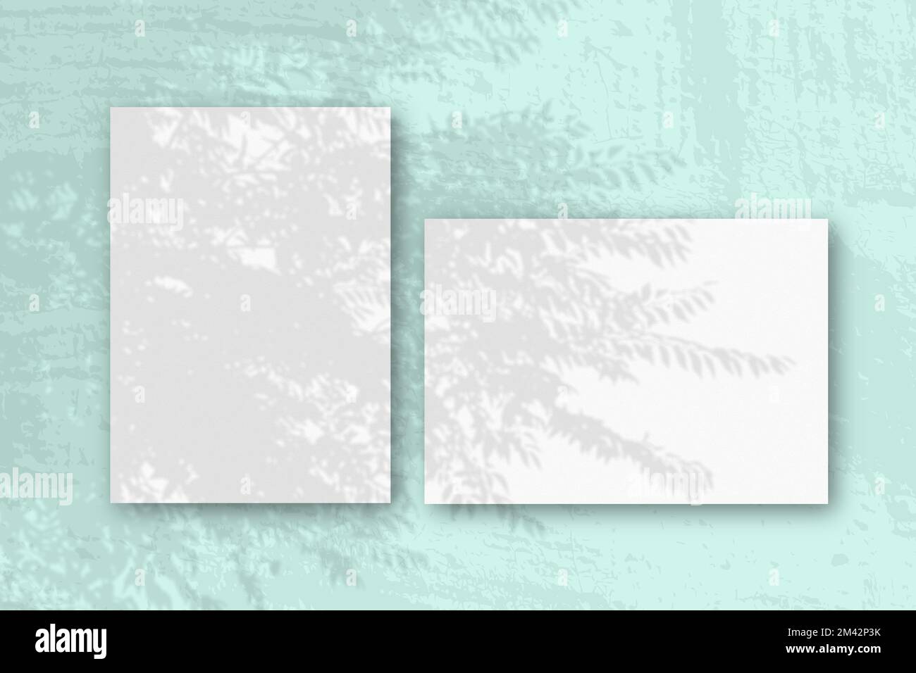 Horizontal and vertical sheets of white textured paper against a blue ...