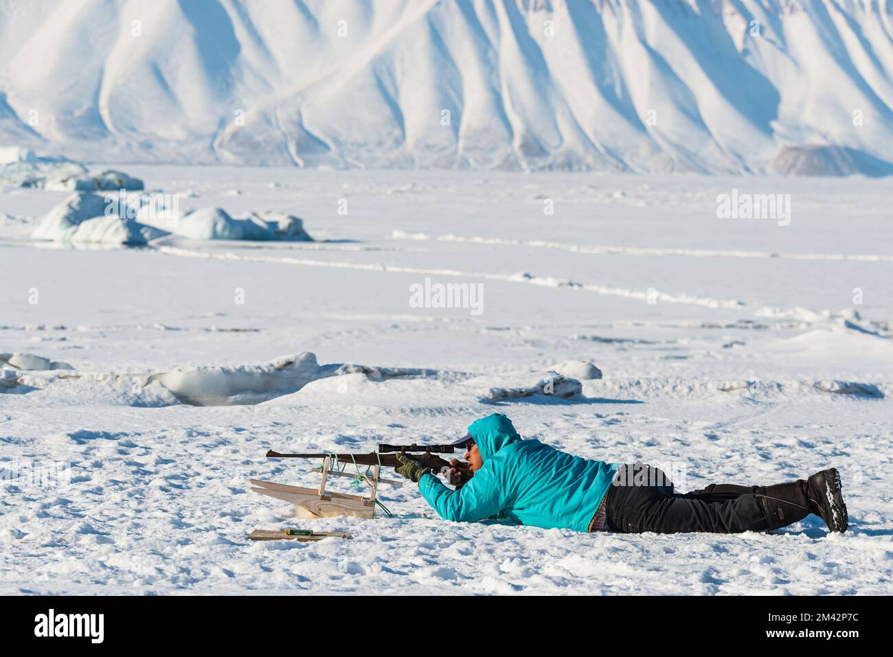 Inuit hunting seal with rifle Stock Photo - Alamy