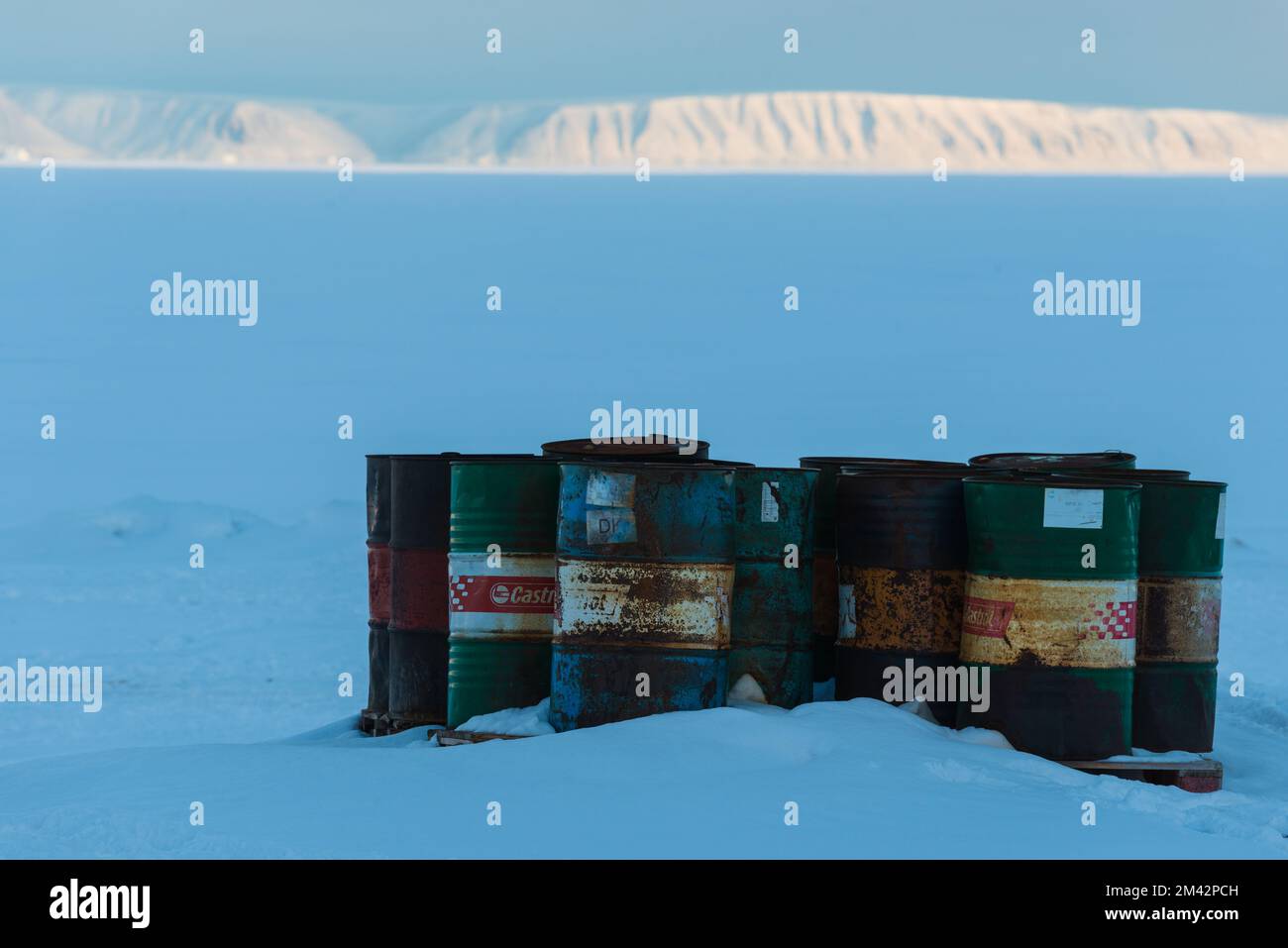 Old rusty oil barrels in front of Greenland mountain Stock Photo - Alamy