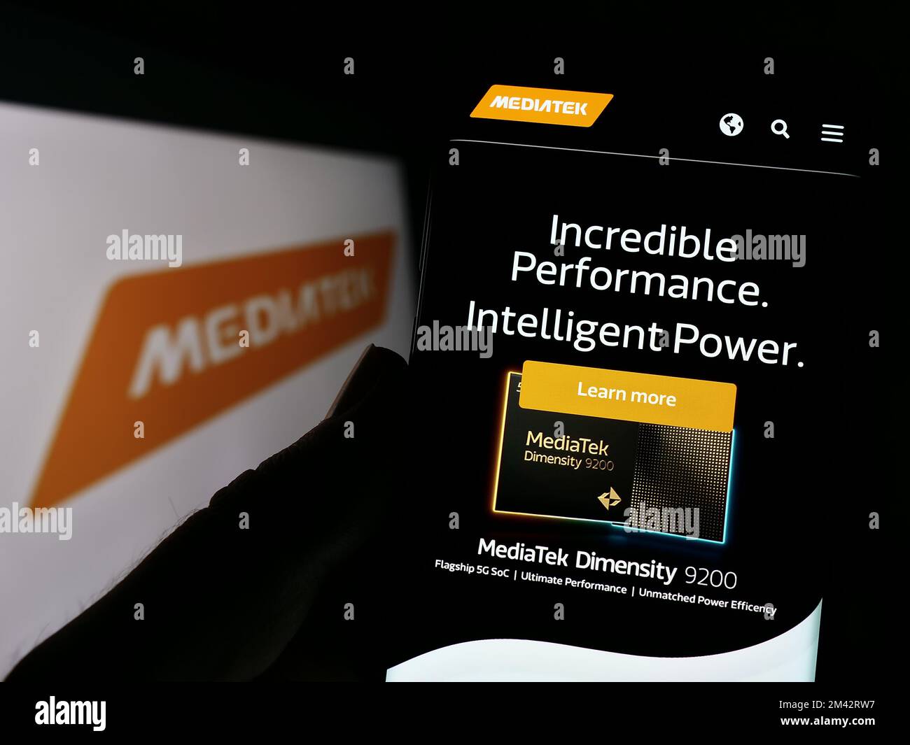 Person holding cellphone with website of Taiwanese semiconductor ...
