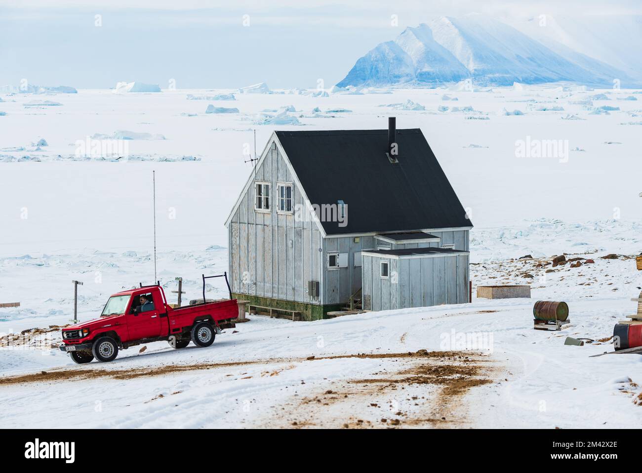 Red car passing by house Stock Photo - Alamy