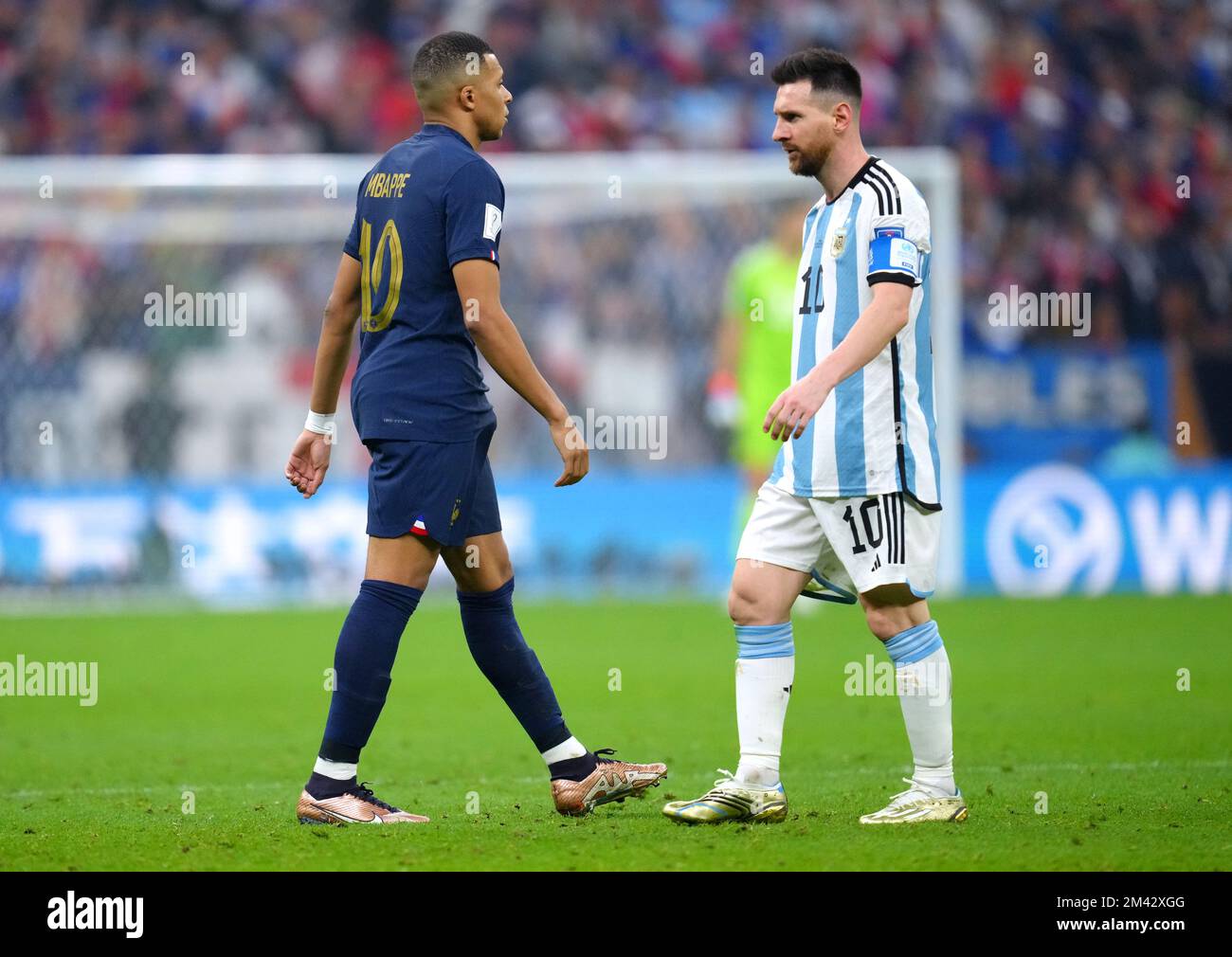 Argentina's Lionel Messi (right) and France's Kylian Mbappe walk towards each other during the ...