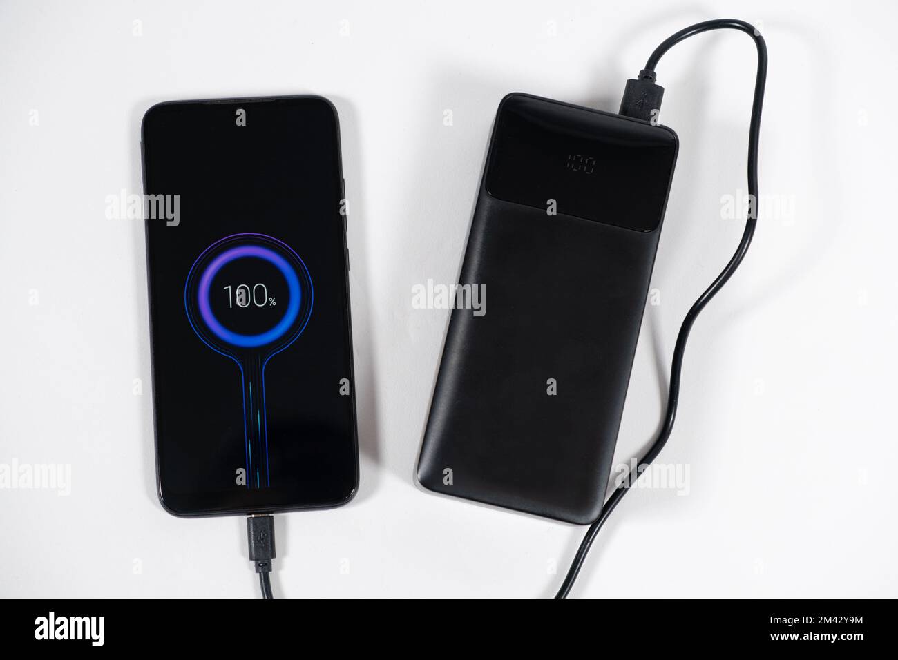 Connecting a mobile phone to a power bank. Charging gadgets from power ...