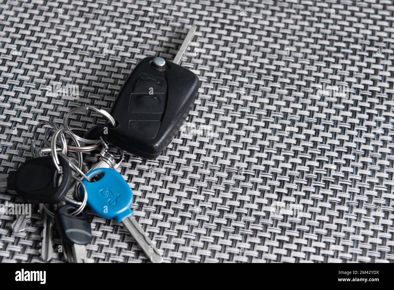 Car, bike and house keys in one bundle. They lie on the table. Elegant ...