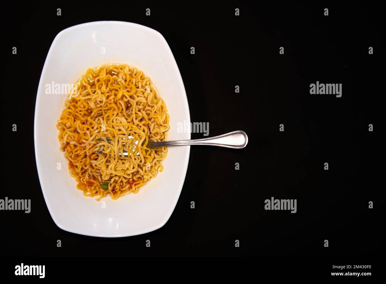 A Instant like maruchan soup in white plate on black background Stock ...