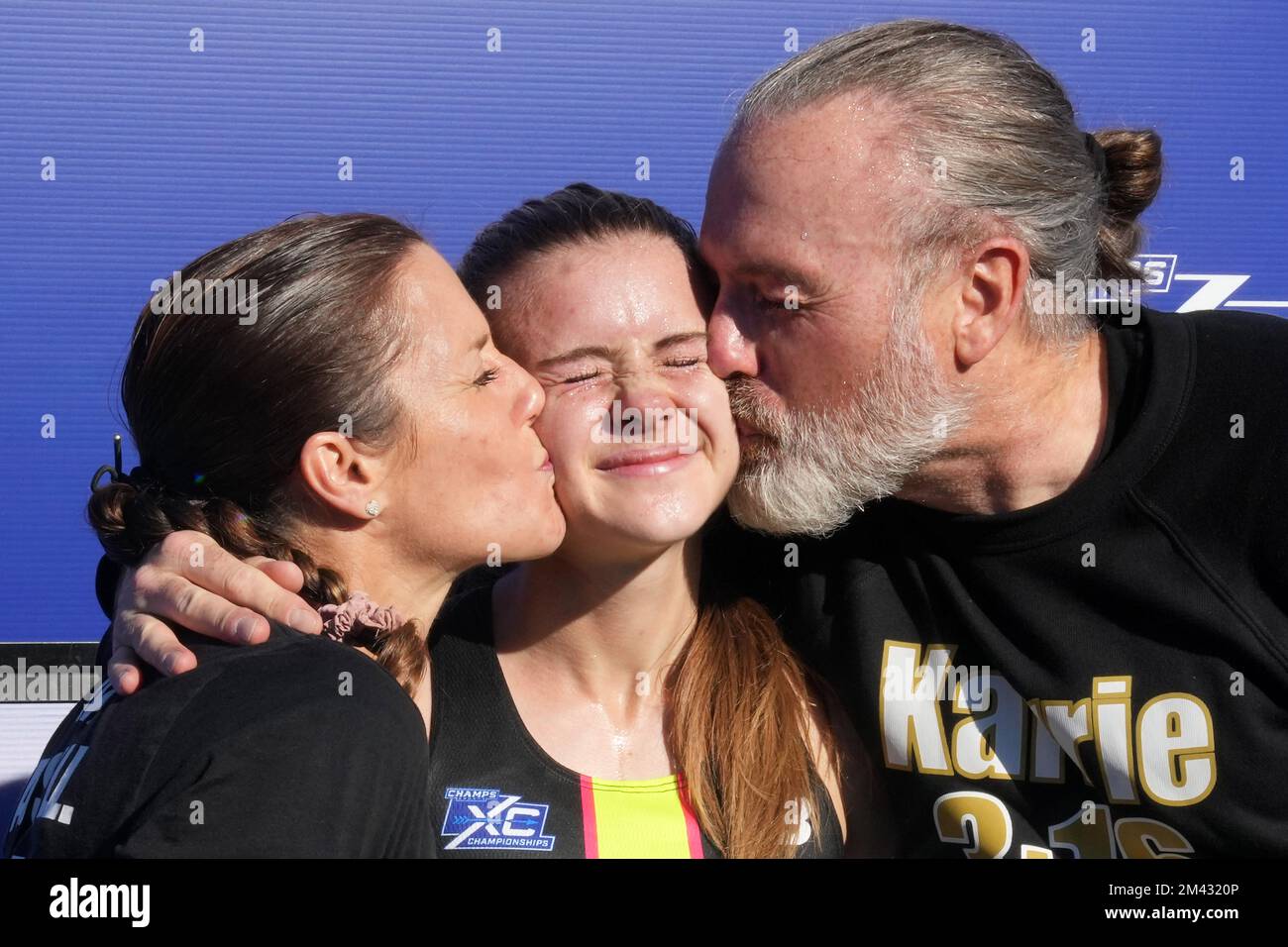 Karrie Baloga (center) is kissed by her parents, mother Katie Baloga ...