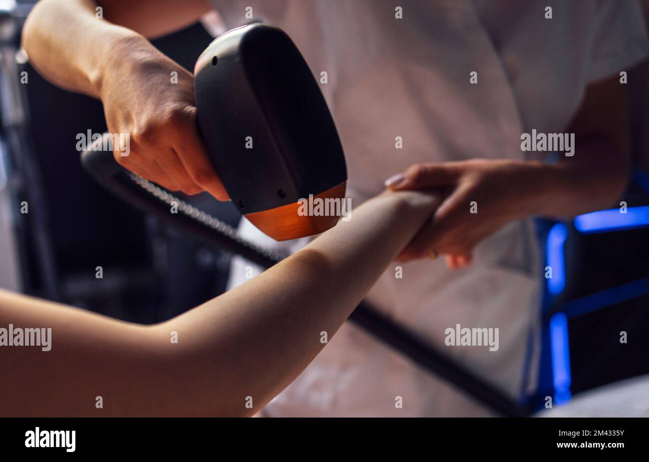 Young woman receiving photo epilation while visiting beauty center on ...