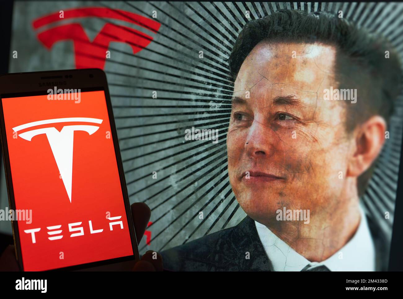 Tesla logo seen on mobile with Elon Musk in the background seen in this ...