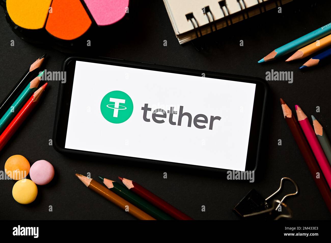 In this photo illustration a Tether logo seen displayed on a smartphone ...