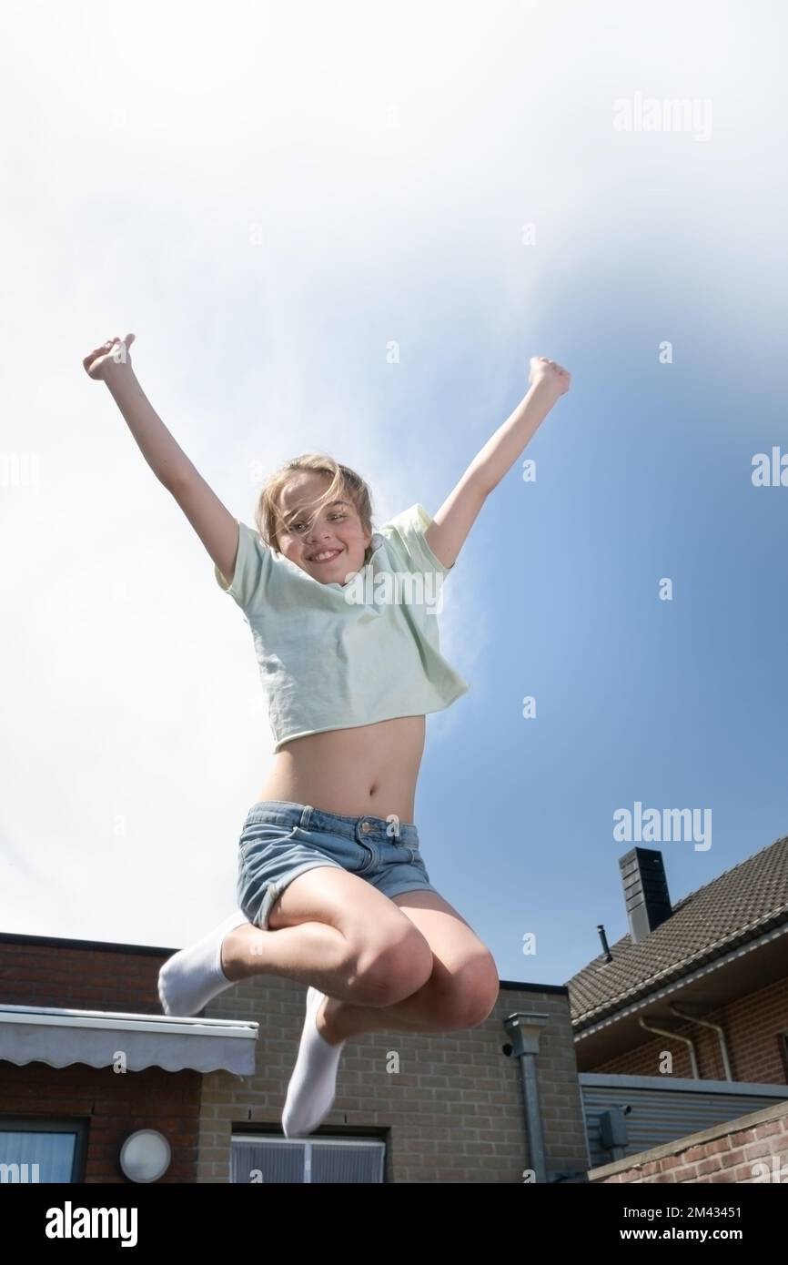 Have a great summer. Girl jump on a trampoline Stock Photo - Alamy