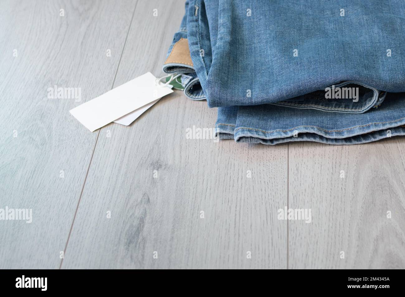 Jeans without inscription on the label . Background with a soft wood ...