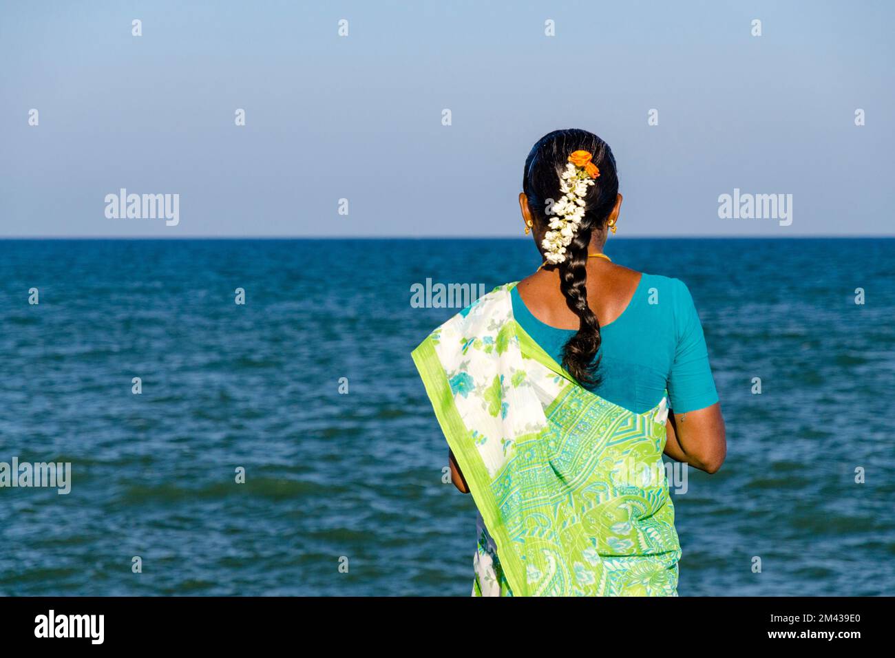 One young lady at the beach, looking out to the sea Stock Photo - Alamy