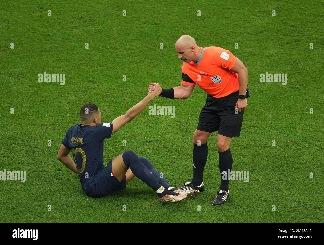 Lusail, Qatar. 18th Dec, 2022. Referee Szymon Marciniak (R) helps ...