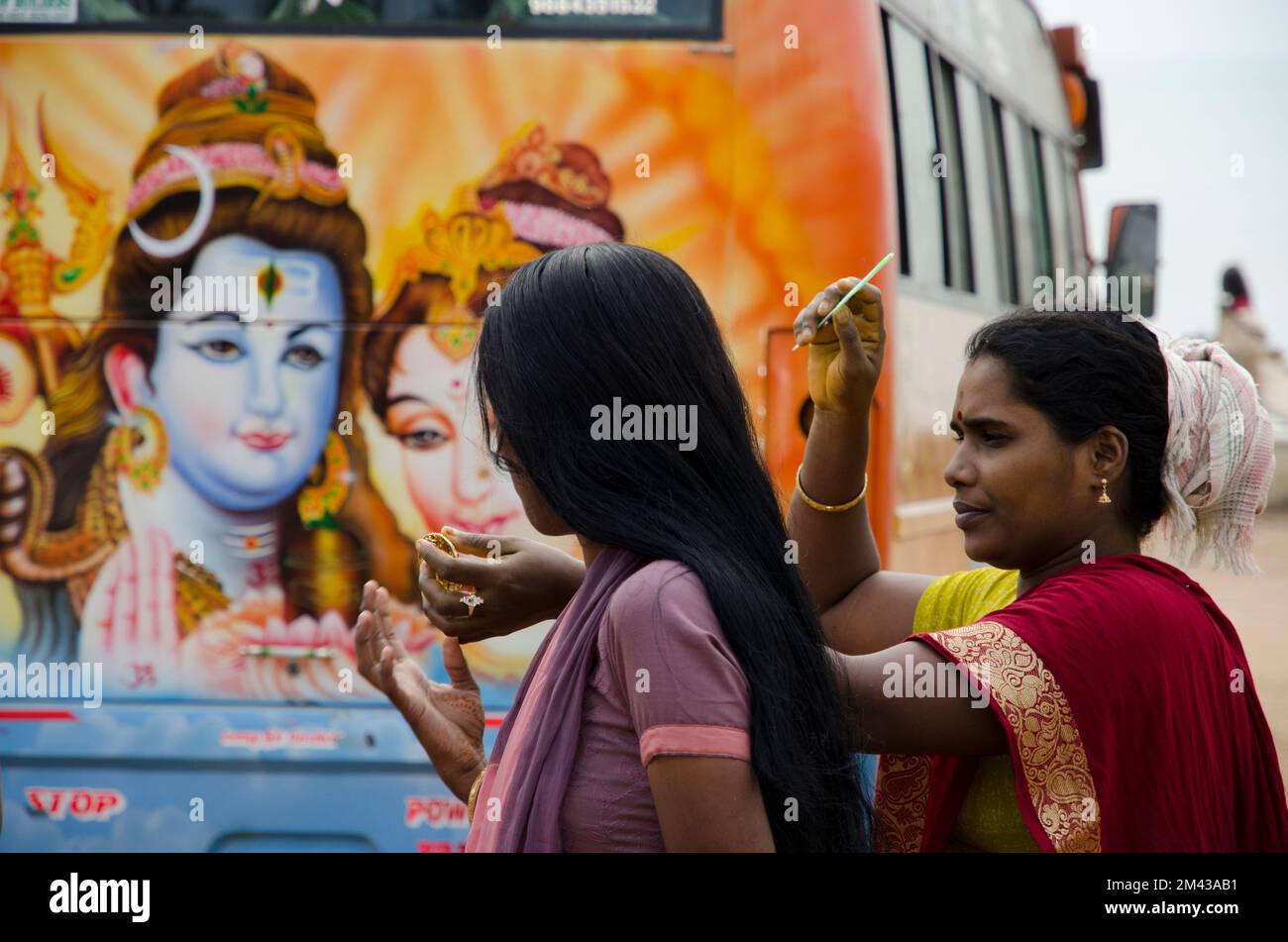 Young ladies on pilgrimage doing their make up behind a beautifully ...