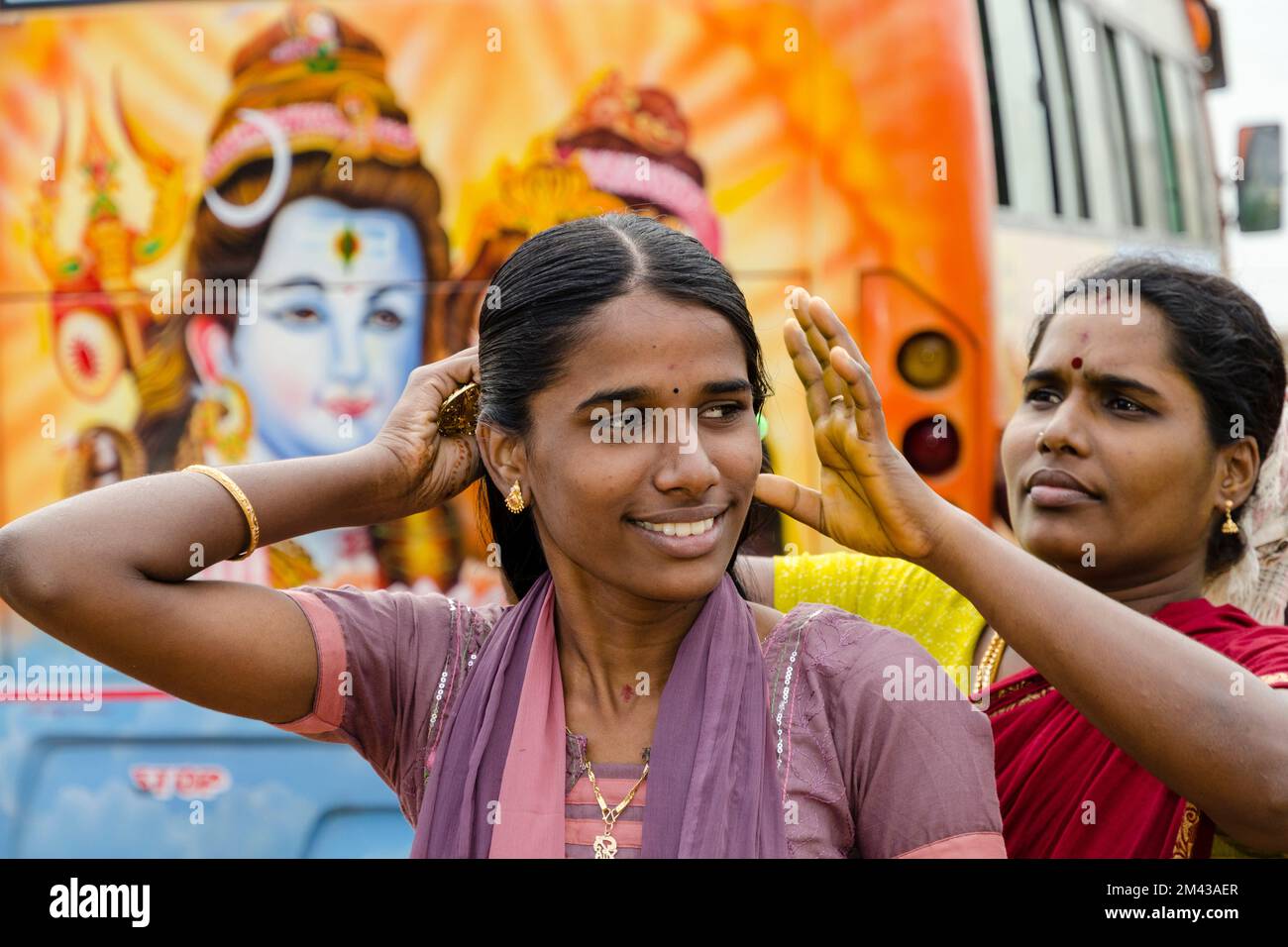 Young ladies on pilgrimage having fun doing their make up behind a ...