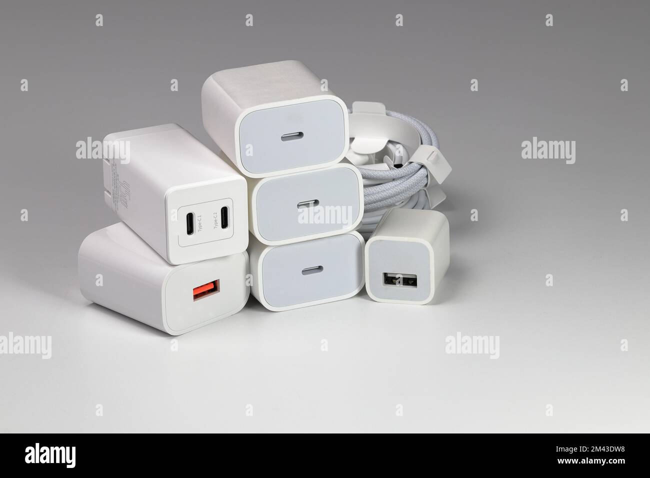 White charger adapter and white USB cable on a white background, New ...