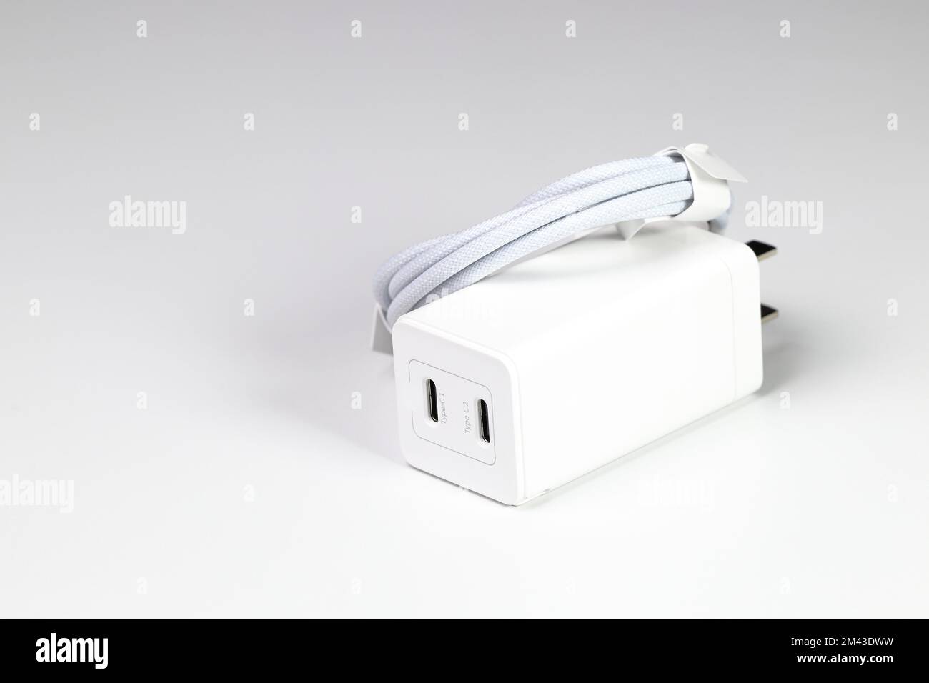 White charger adapter and white USB cable on a white background, New ...