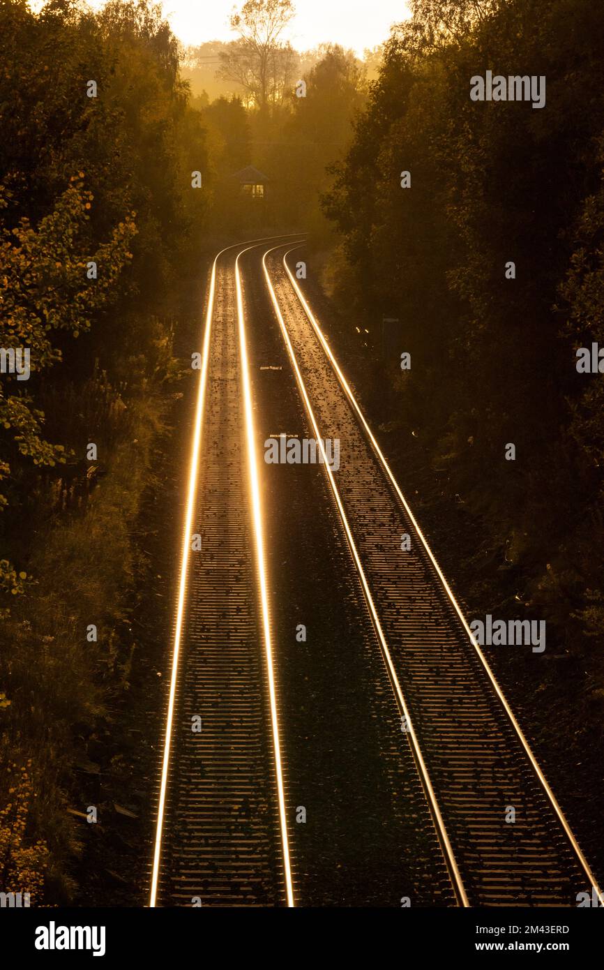 Sunset on the Ribble Valley railway line at Gisburn with a golden glint ...