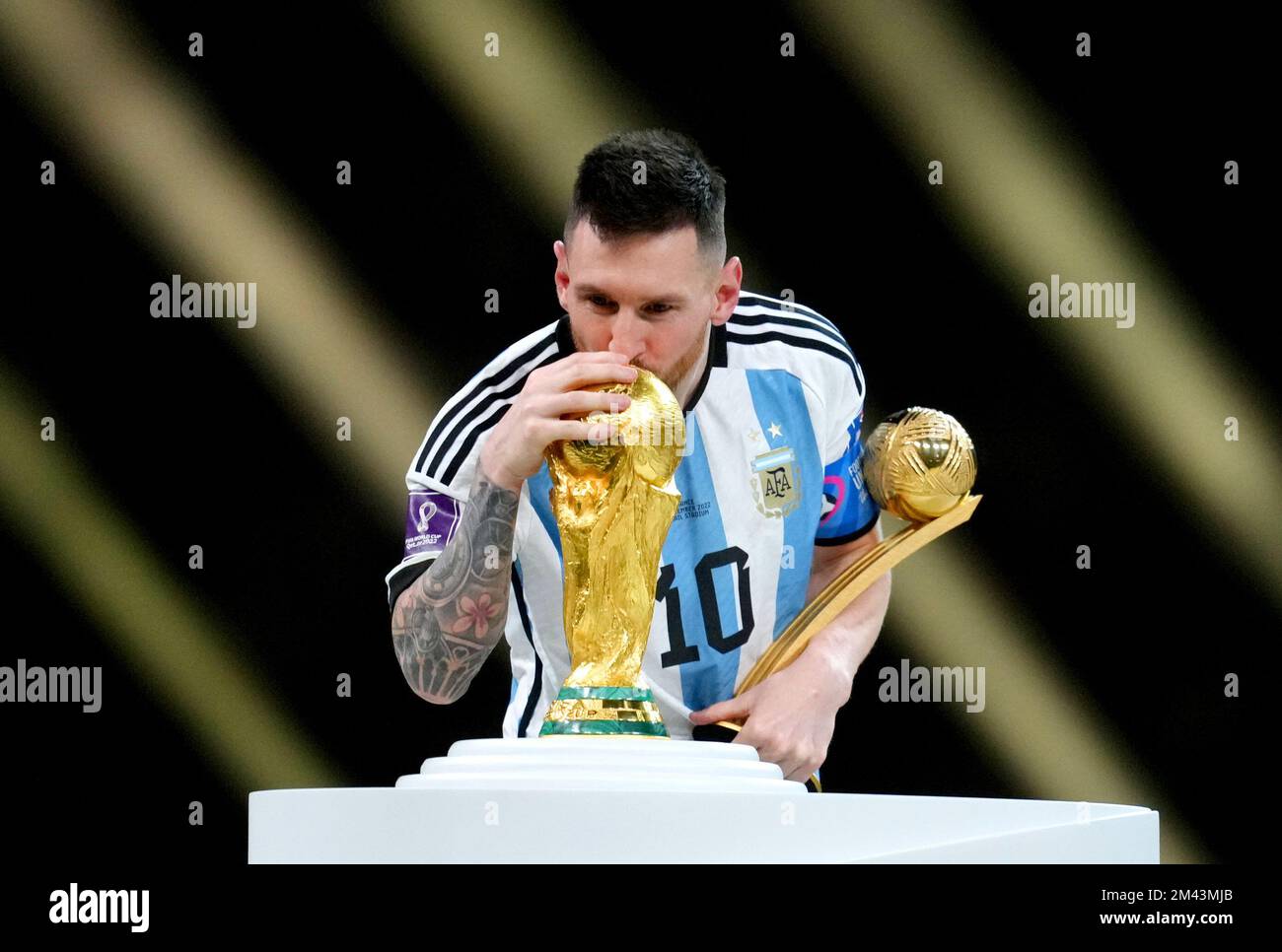 Argentina's Lionel Messi kisses the FIFA World Cup trophy after being ...